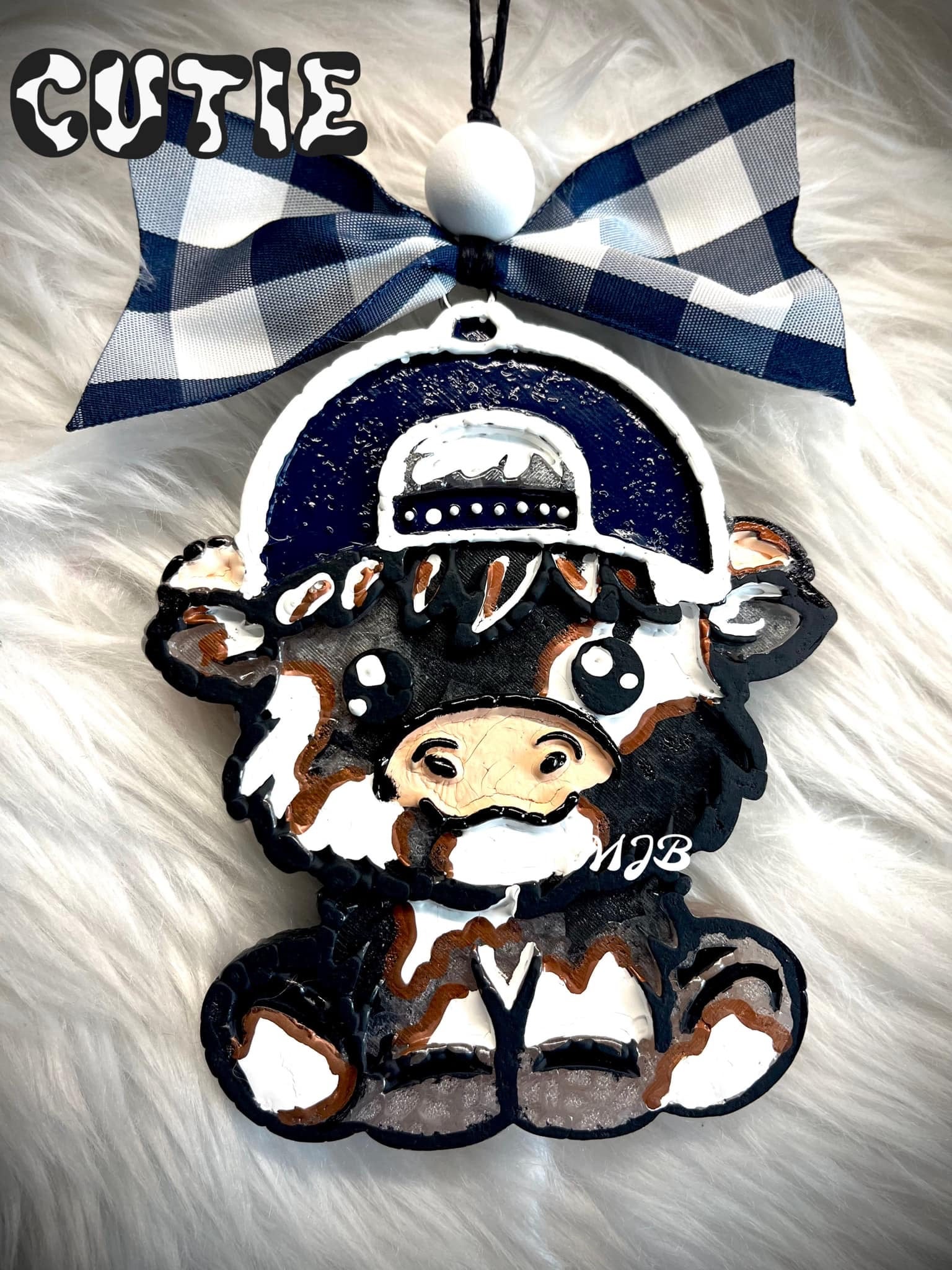 Highland cow with hat backwards | Kay J and Co.